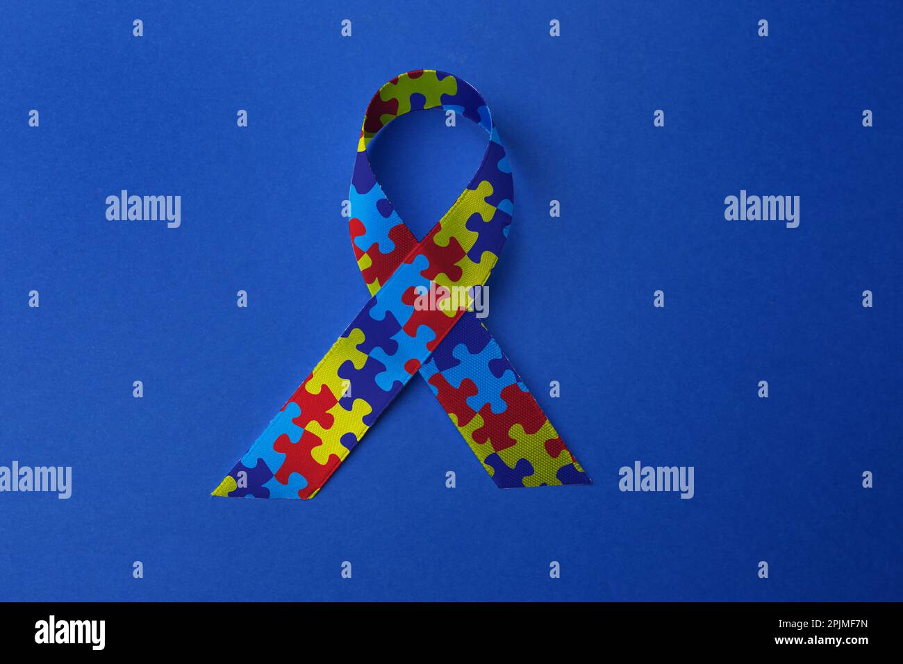 World Autism Awareness Day. Colorful puzzle ribbon on blue background ...