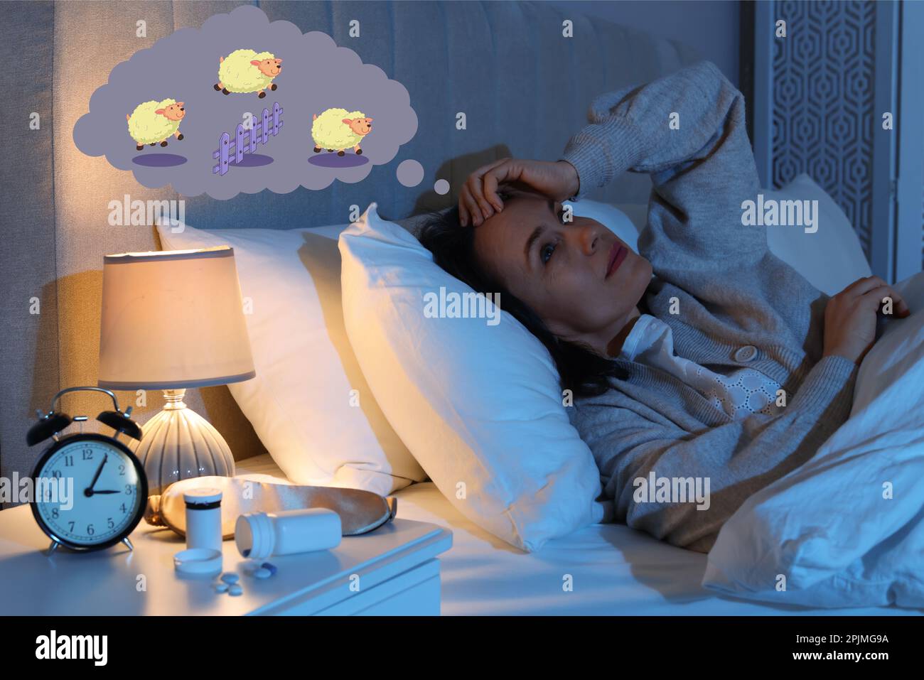 Mature woman trying to fall asleep counting sheep in bed at night Stock ...