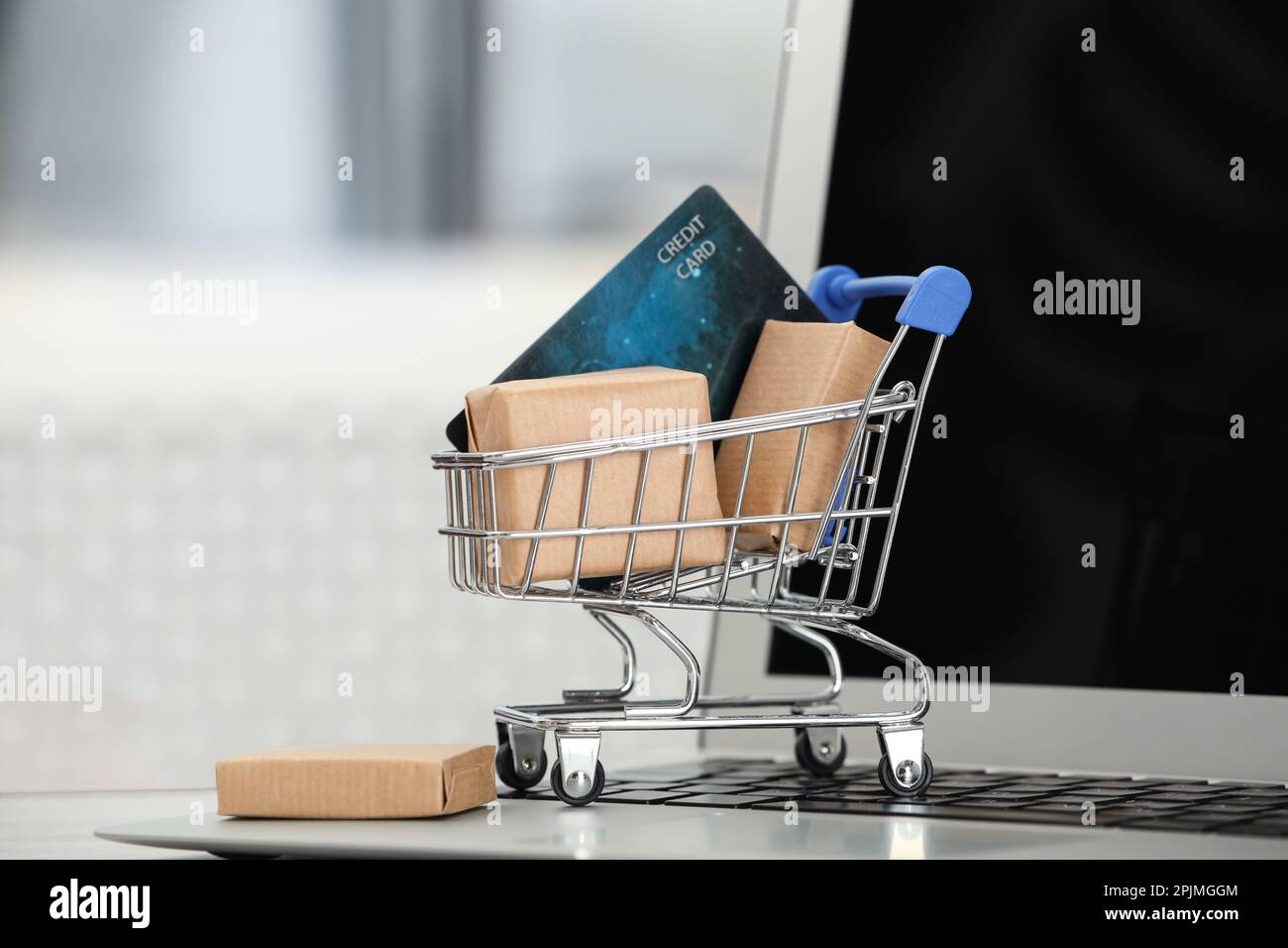 Online payment concept. Small shopping cart with bank card, boxes and ...