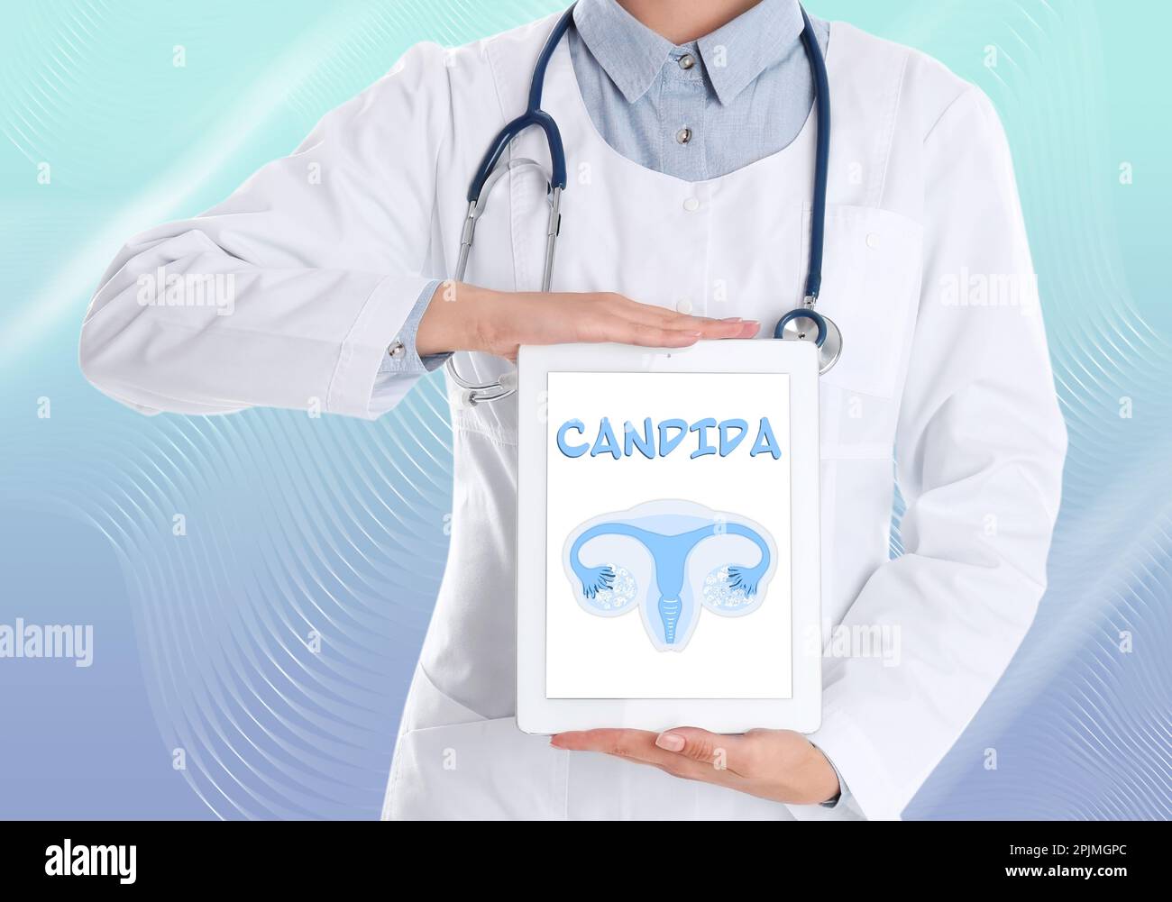 Doctor holding modern tablet with word Candida and illustration of ...