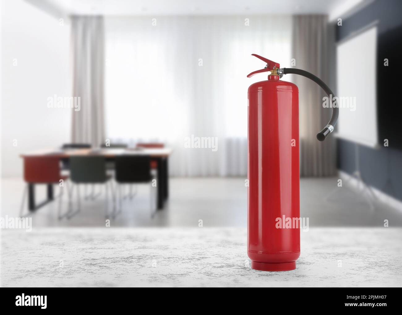 Fire extinguisher on stone table in meeting room. Space for text Stock ...