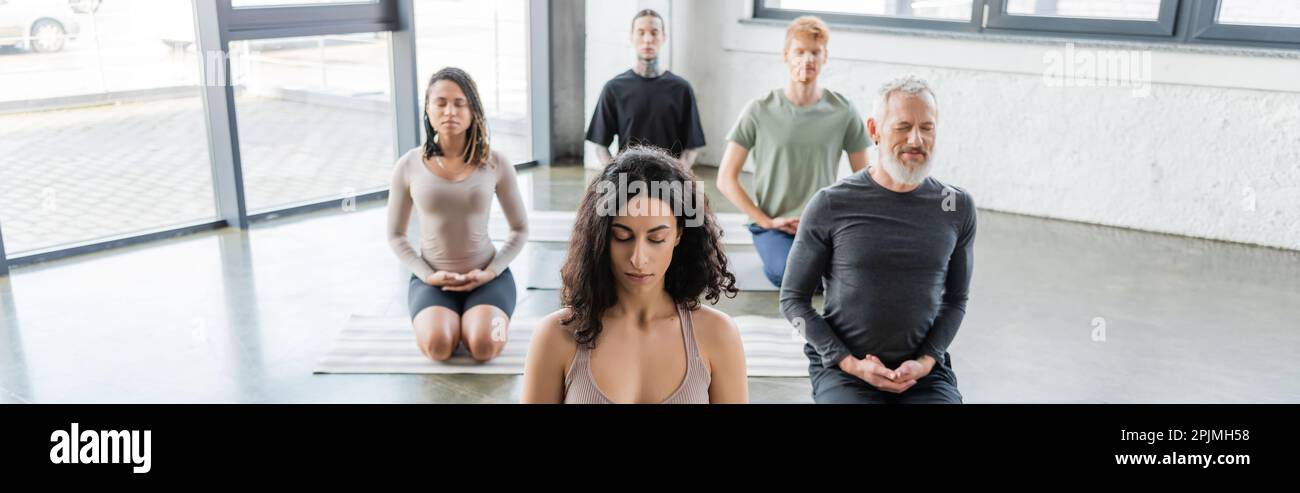 Yoga group meditating on mats hi-res stock photography and images - Alamy
