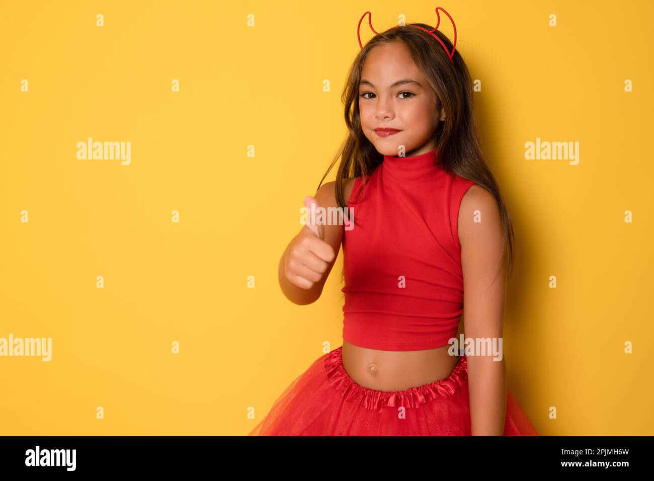 Closeup photo of funny little lady with long hair and headband playing ...
