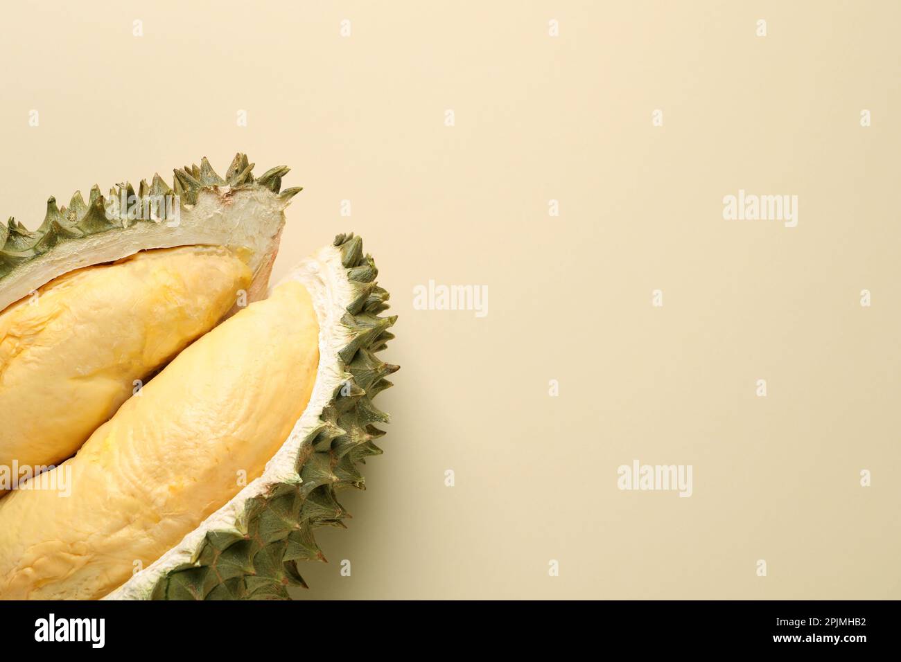 Pieces of fresh ripe durian on beige background, flat lay. Space for ...