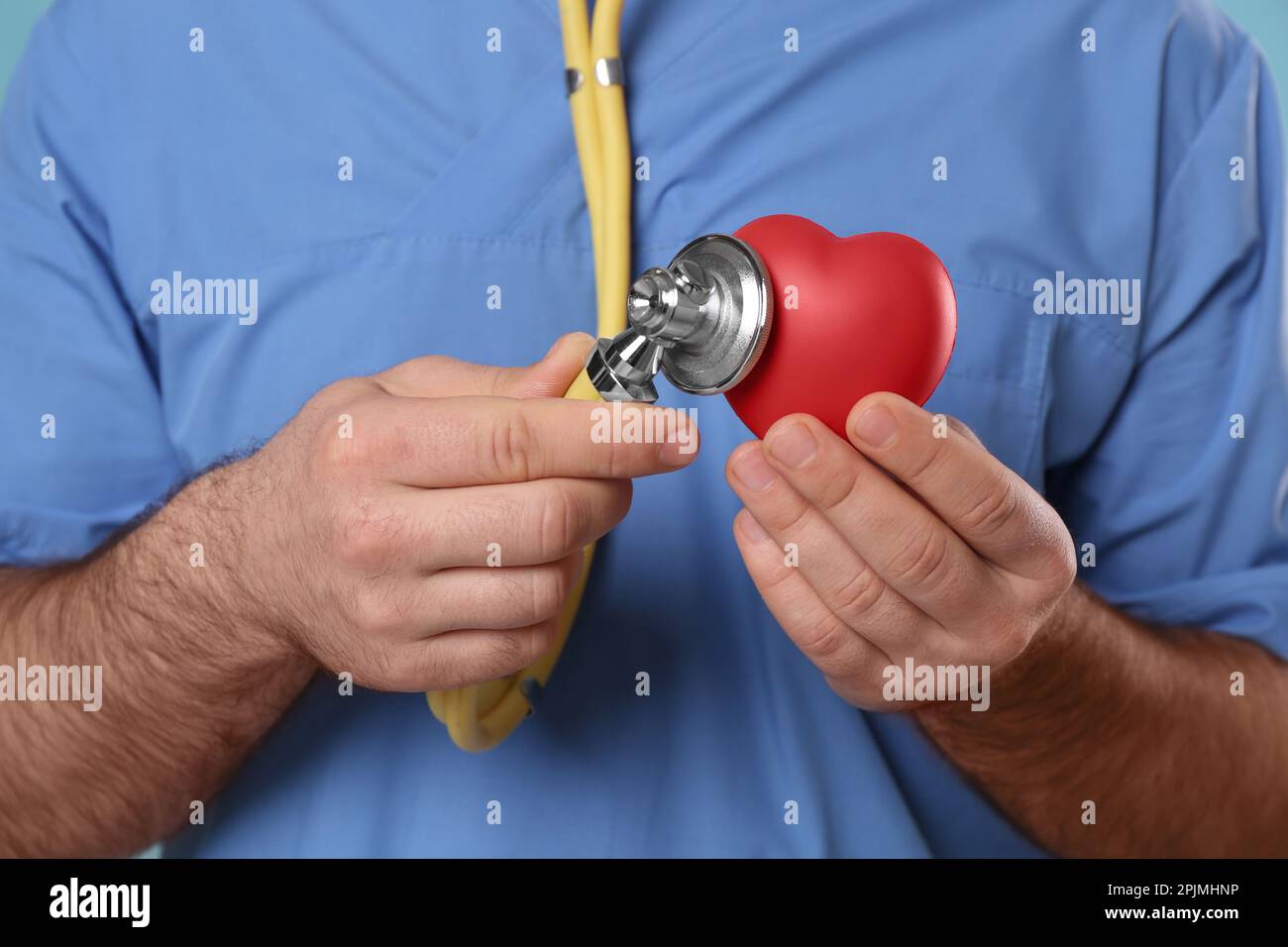 Doctor with stethoscope and red heart, closeup. Cardiology concept ...