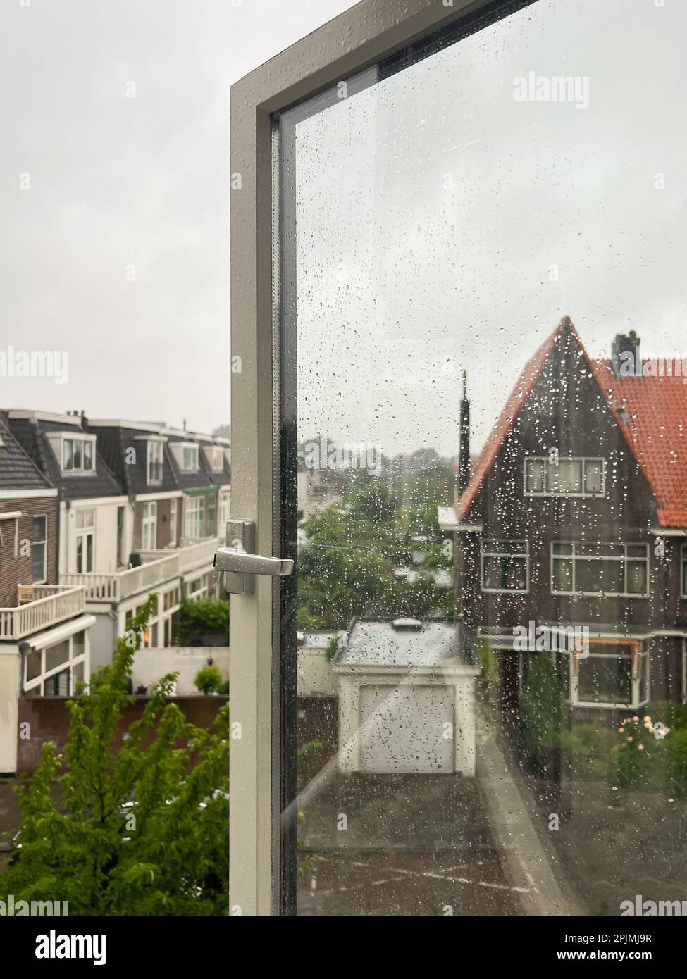Beautiful cityscape with buildings on rainy day, view through open ...