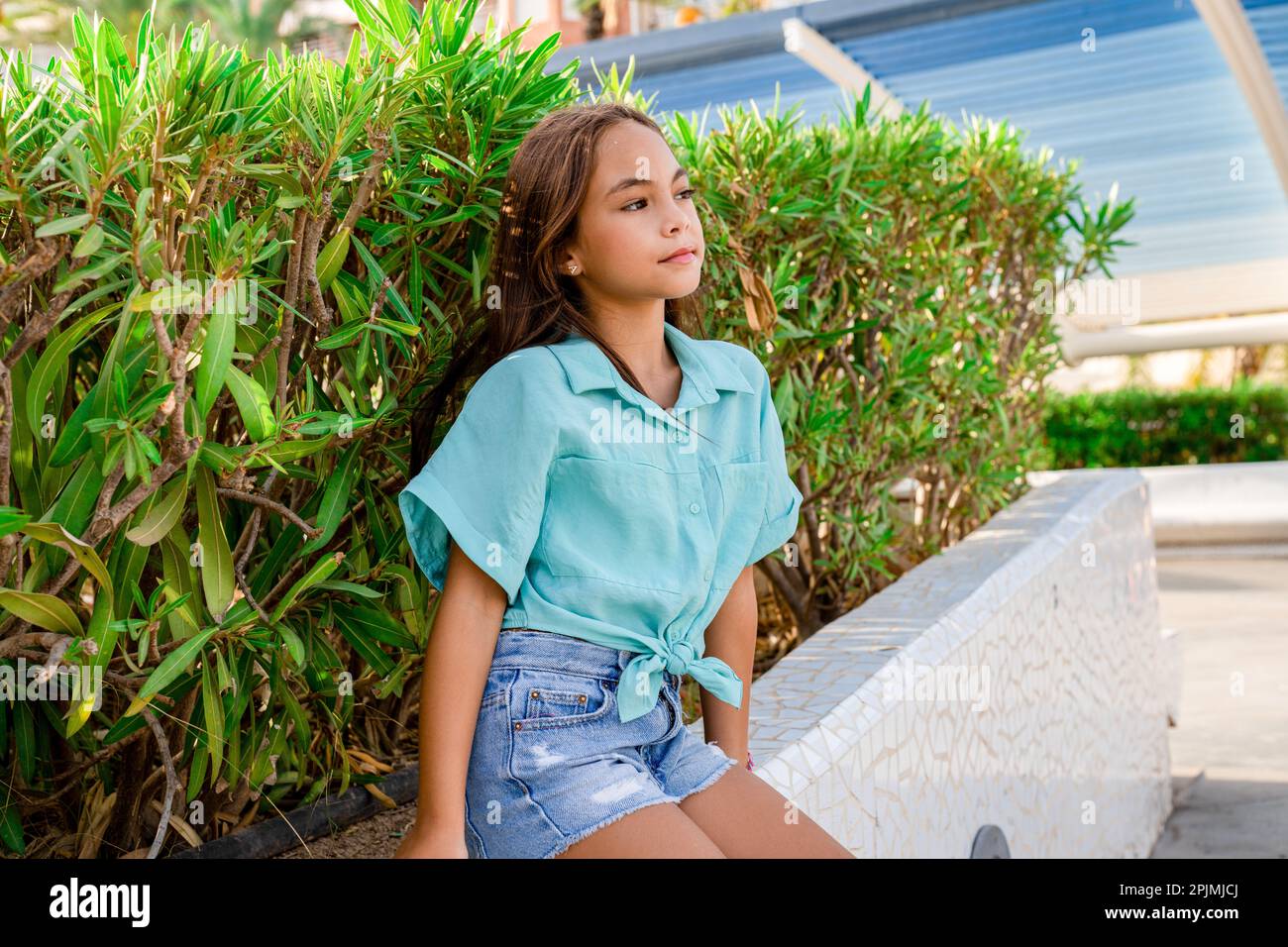 Child girl portrait sitting on the bench in Summer Park Stock Photo - Alamy