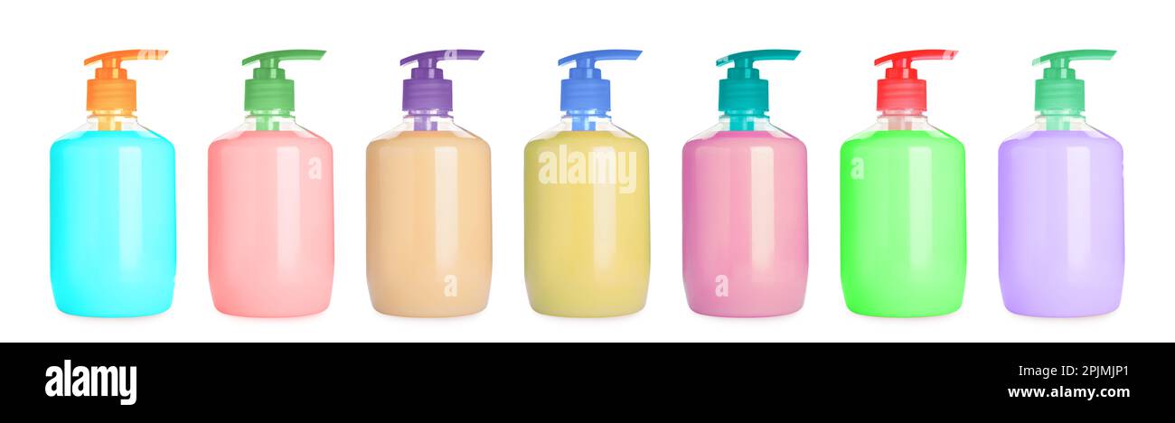 Set with bottles of multicolored liquid soap on white background ...