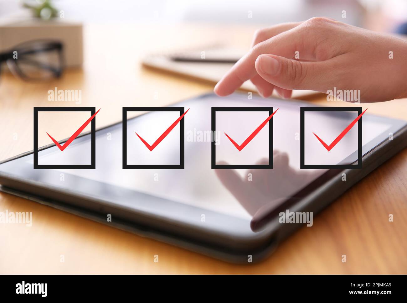 Illustration of check boxes with marks and woman using tablet at wooden ...