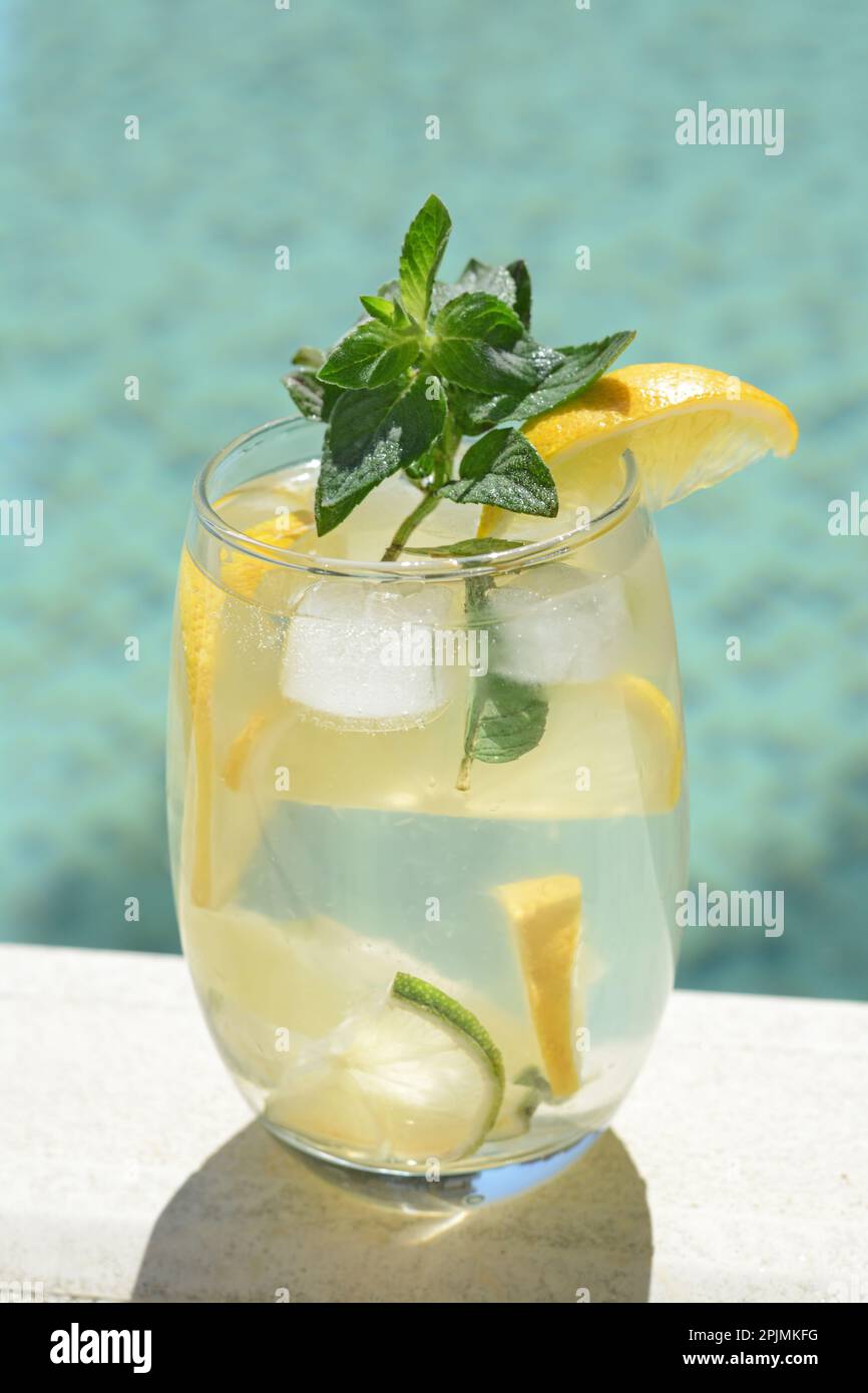 Refreshing drink with citrus slices and mint near swimming pool Stock ...