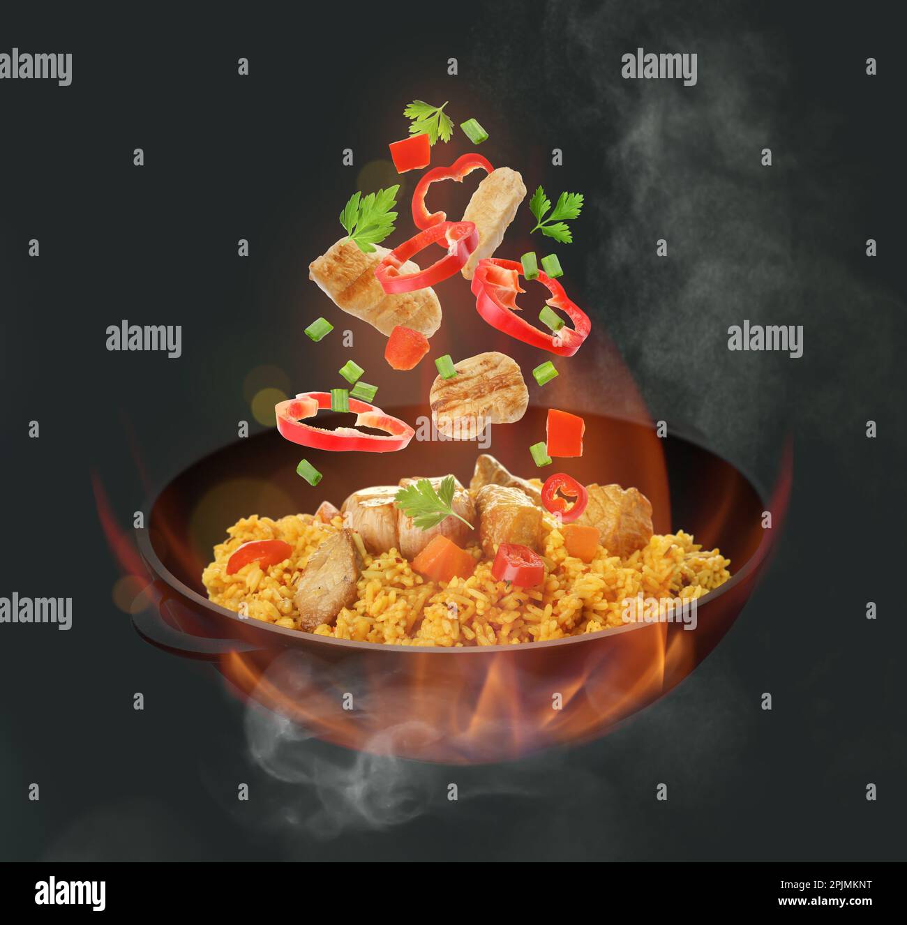 Wok with tasty ingredients and fire on dark background Stock Photo - Alamy