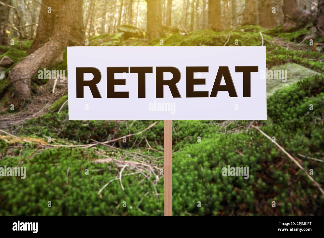 Wooden sign with word Retreat in beautiful forest Stock Photo - Alamy