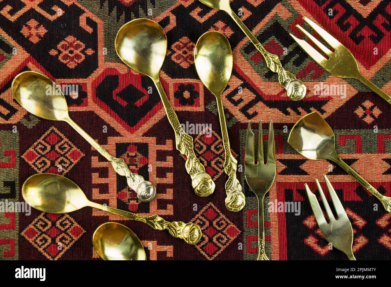 large group of golden spoons on the table, Vintage and retro spoons set ...