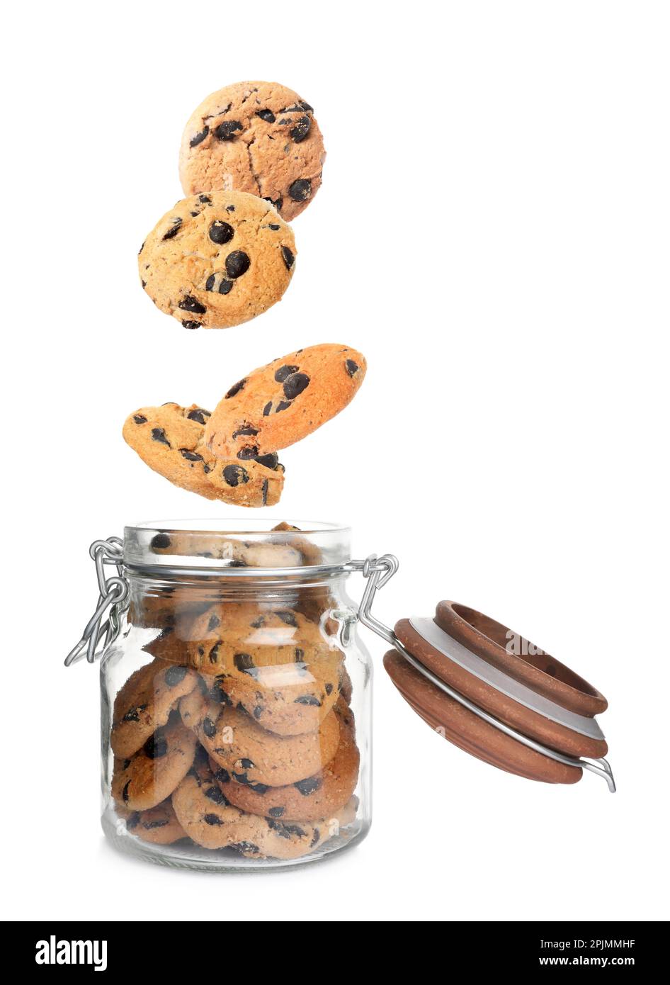 Tasty chocolate chip cookies falling into glass jar on white background ...