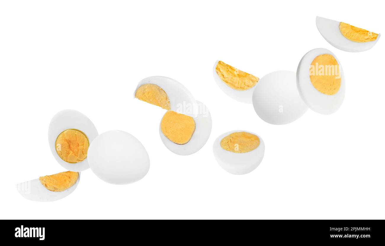 Tasty hard boiled eggs falling on white background Stock Photo - Alamy