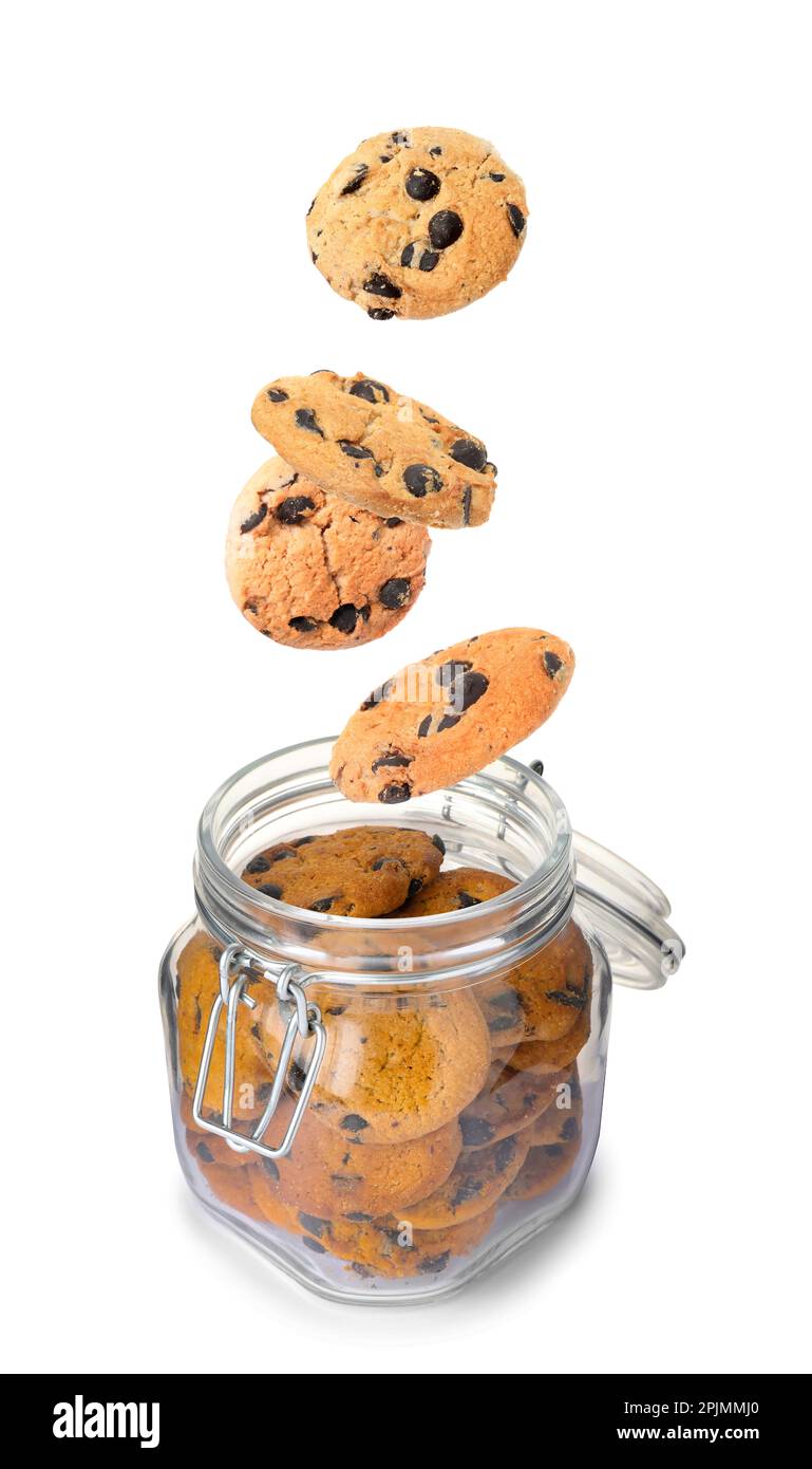 Tasty chocolate chip cookies falling into glass jar on white background ...