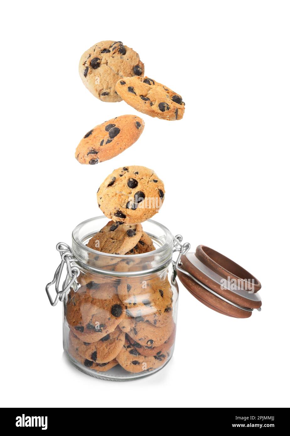 Tasty chocolate chip cookies falling into glass jar on white background ...