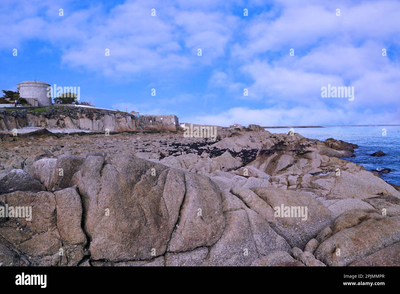 Rock formations on the coast at Sandycove, Ireland, with the Martello ...