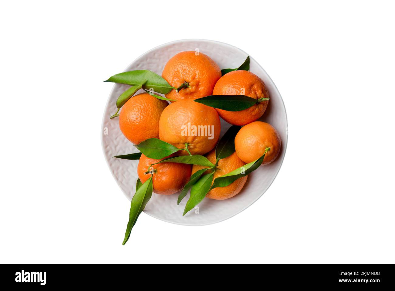 Fresh cutted clementines and whole mandarin over round plate isolated ...