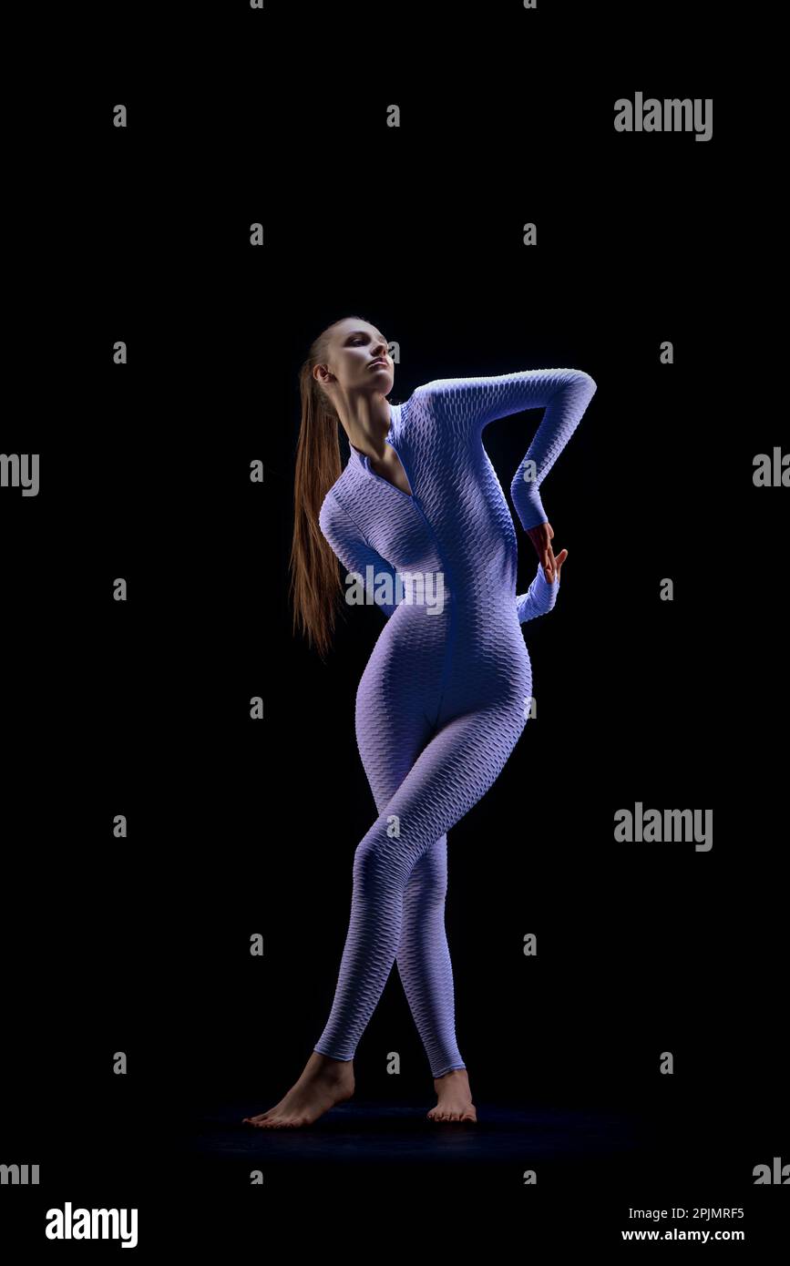 Portrait of beautiful young girl wearing suit standing in unusual ...