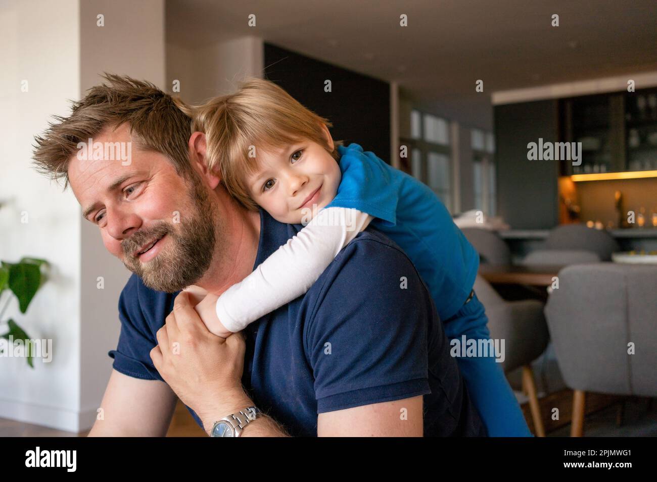 Little bond boy giving a hug to his dad at home Stock Photo - Alamy