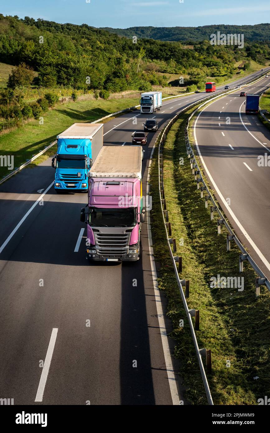 Highway transportation with Trucks, cars and bus Stock Photo - Alamy