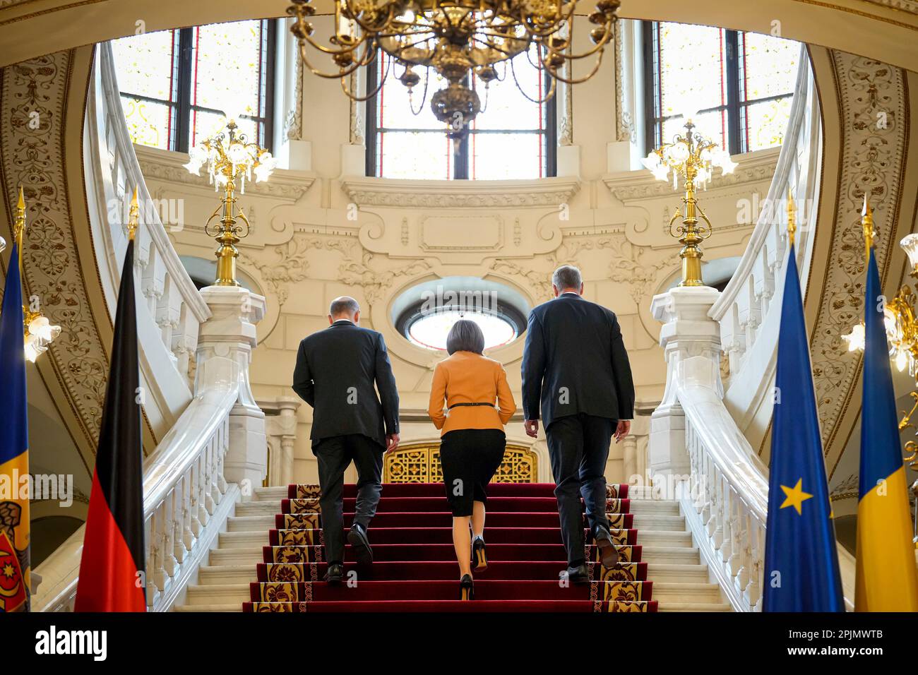 German Chancellor Olaf Scholz, left, walks up a flight of stairs with ...