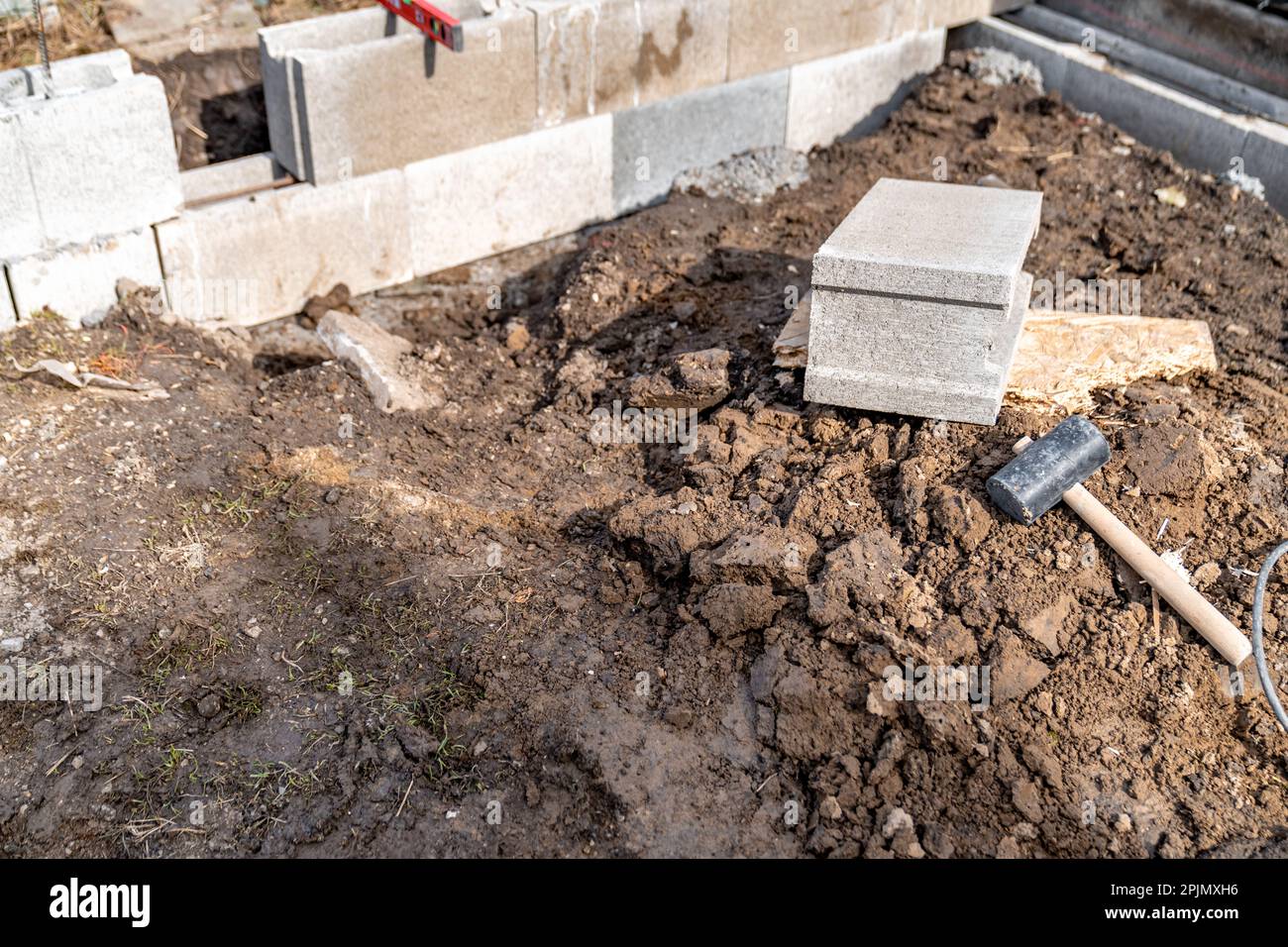 construction of a building made of concrete bricks. using a hammer and ...