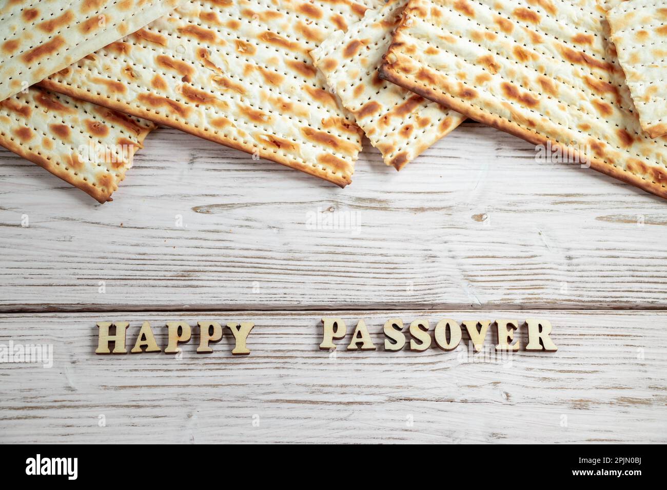 Happy Passover. Matzah on white wooden background. Traditional Jewish ...