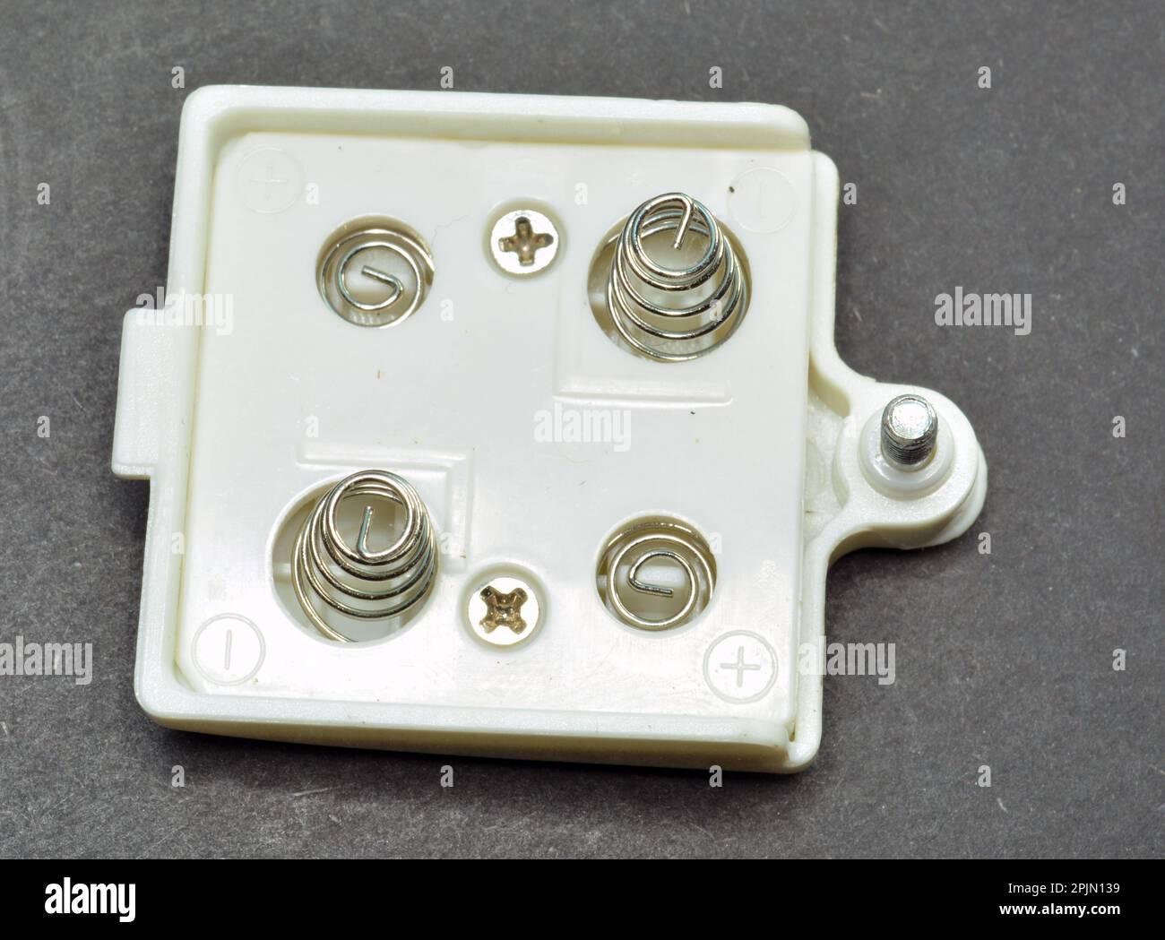 Plastic battery lid with metal bolts and metal spring contacs Stock ...