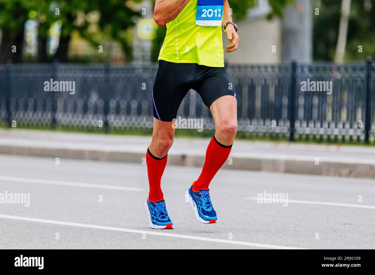 male runner in compression socks run marathon race, bright sportswear ...