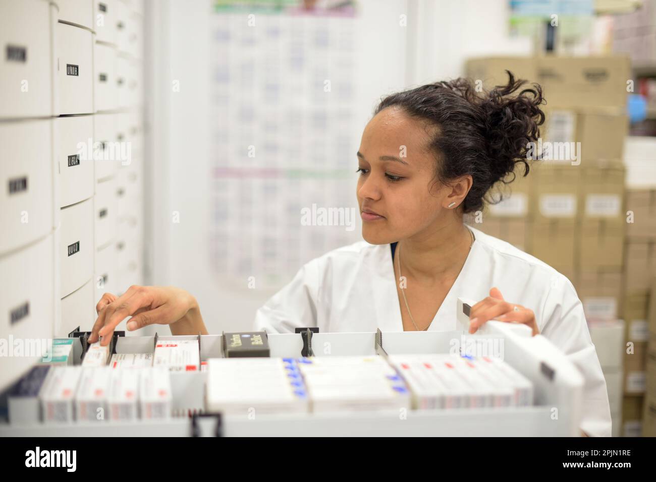 Young pharmacist checking medicine hi-res stock photography and images ...