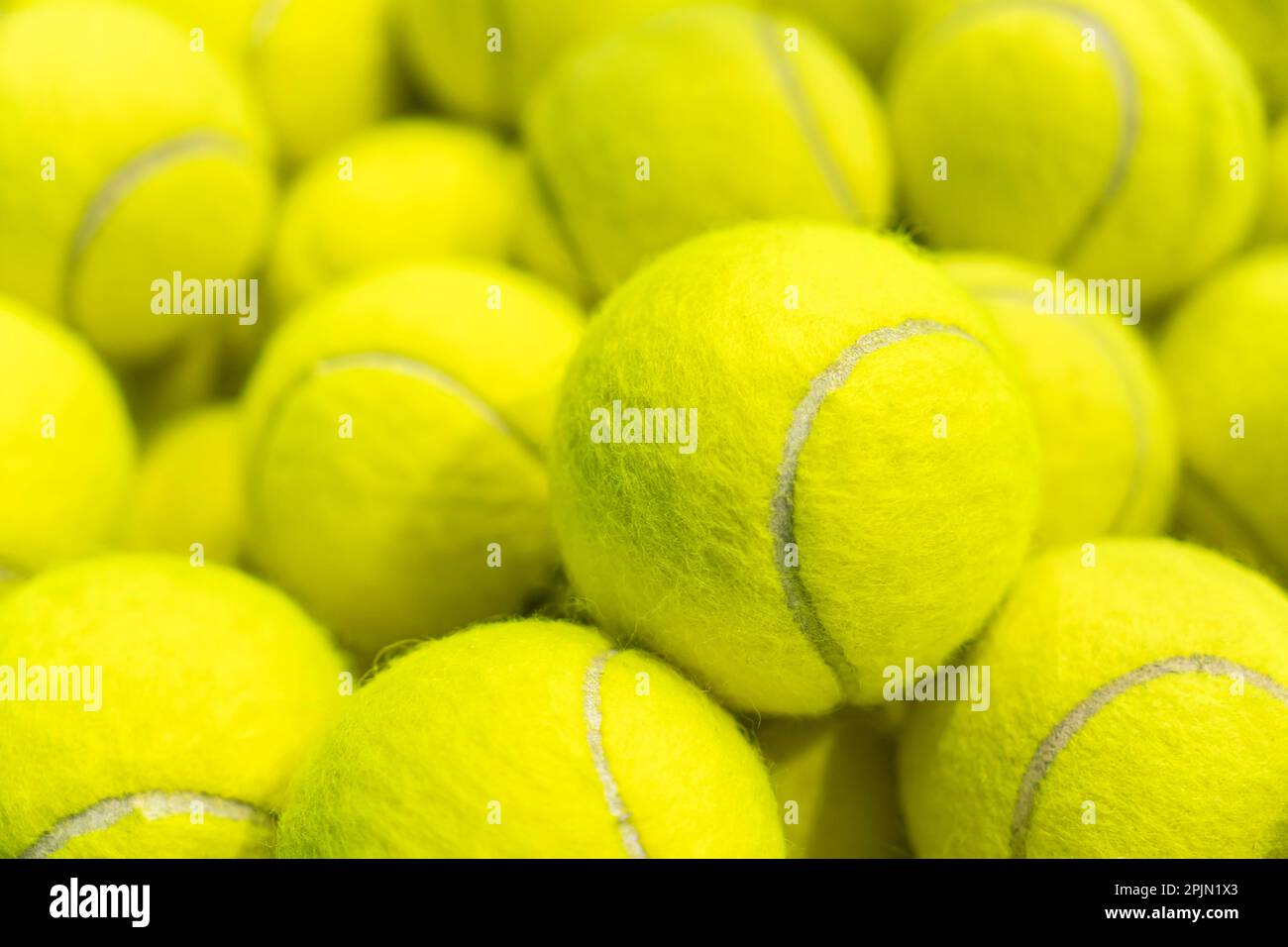 lot of bright yellow tennis balls as a background. close-up Stock Photo ...