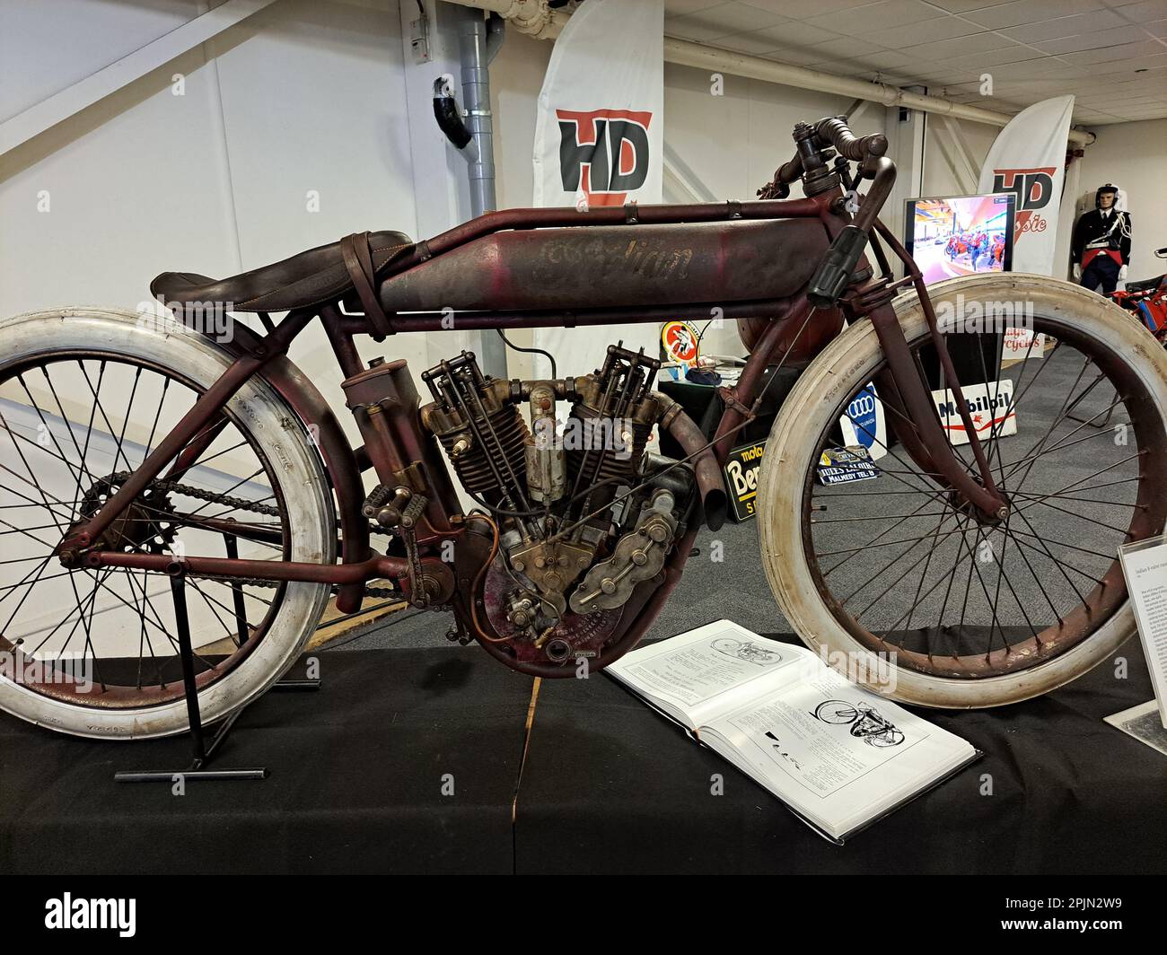 A classic Indian motorcycle is on display in a museum, featuring ...