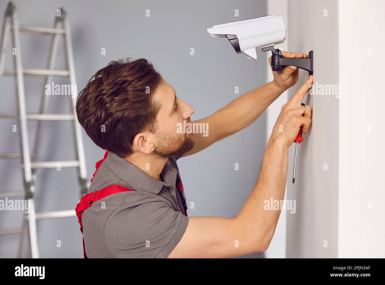 Security surveillance technician adjusting cctv hi-res stock ...