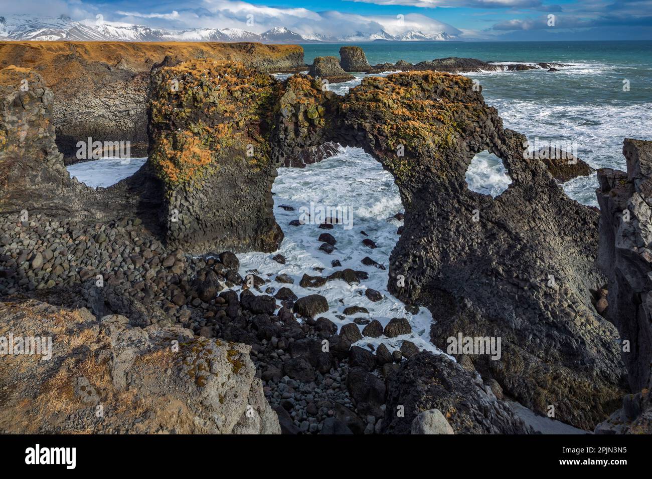 Gatklettur ("Hellnar Arch"), a stunning rock arch and basalt coastline ...