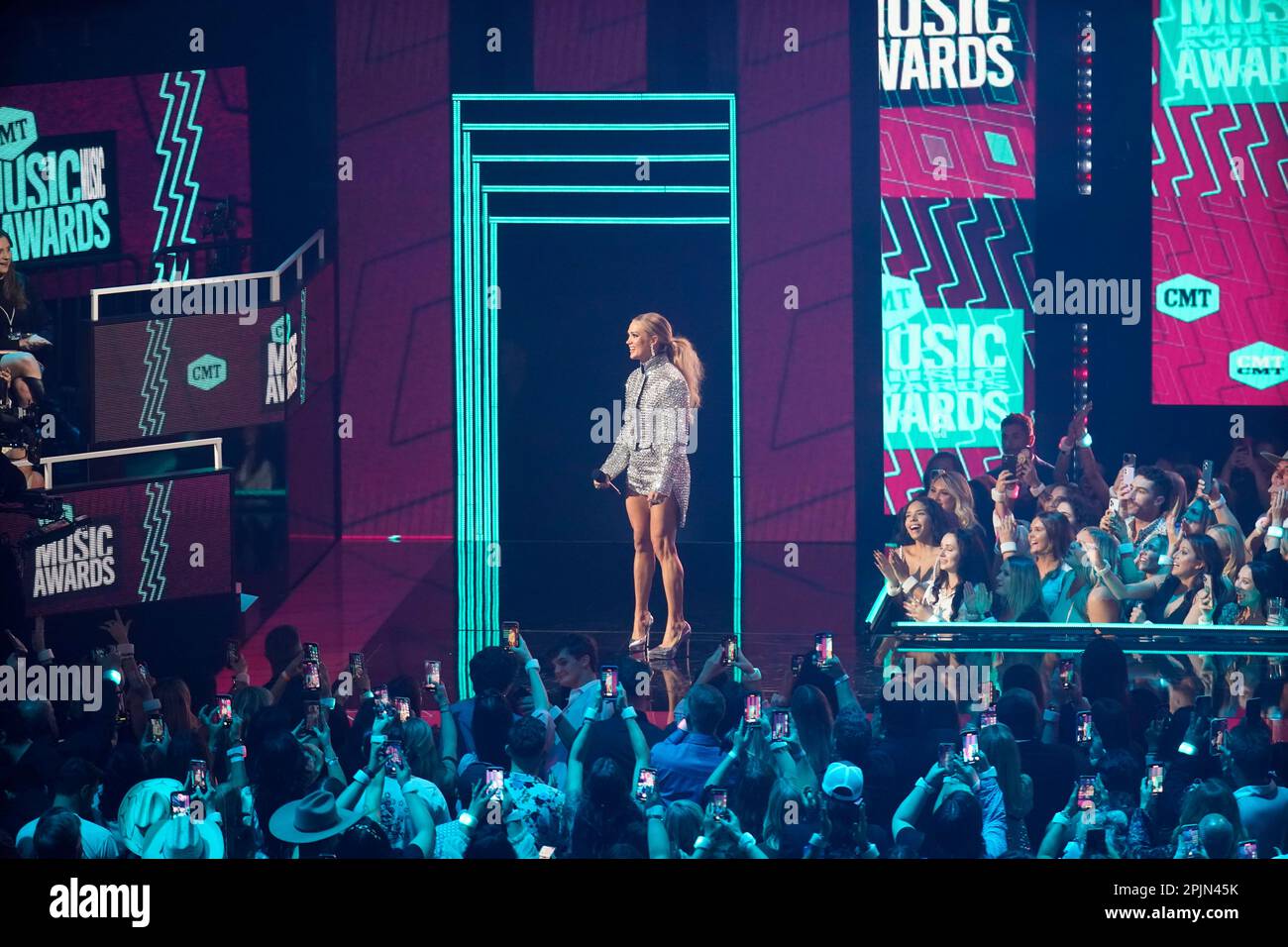 Audience members take cellphone video as presenter CARRIE UNDERWOOD ...