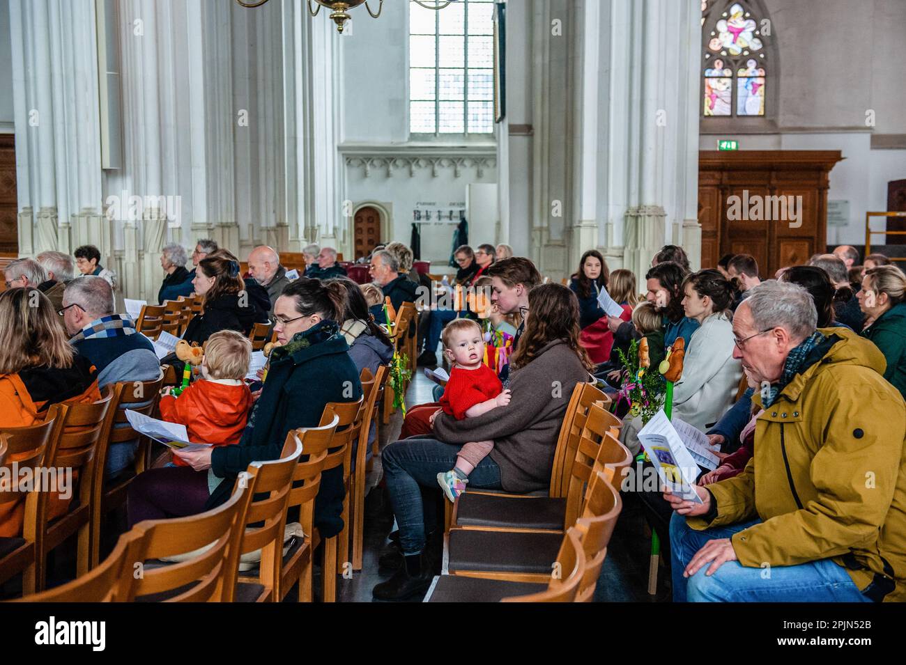 People are seen listening to the reverend during a short religious ...