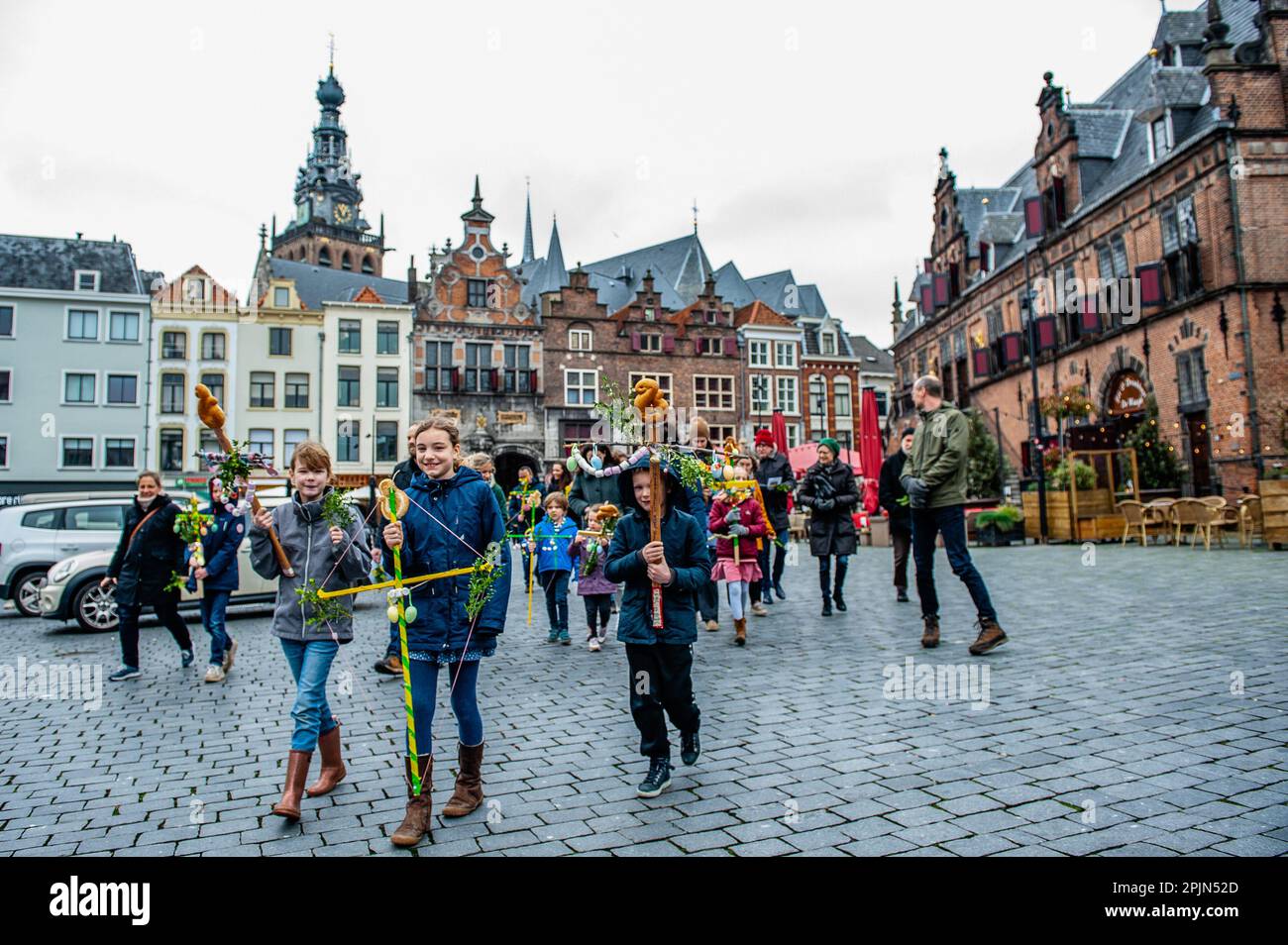 Children are seen walking in a procession while holding decorated palm ...