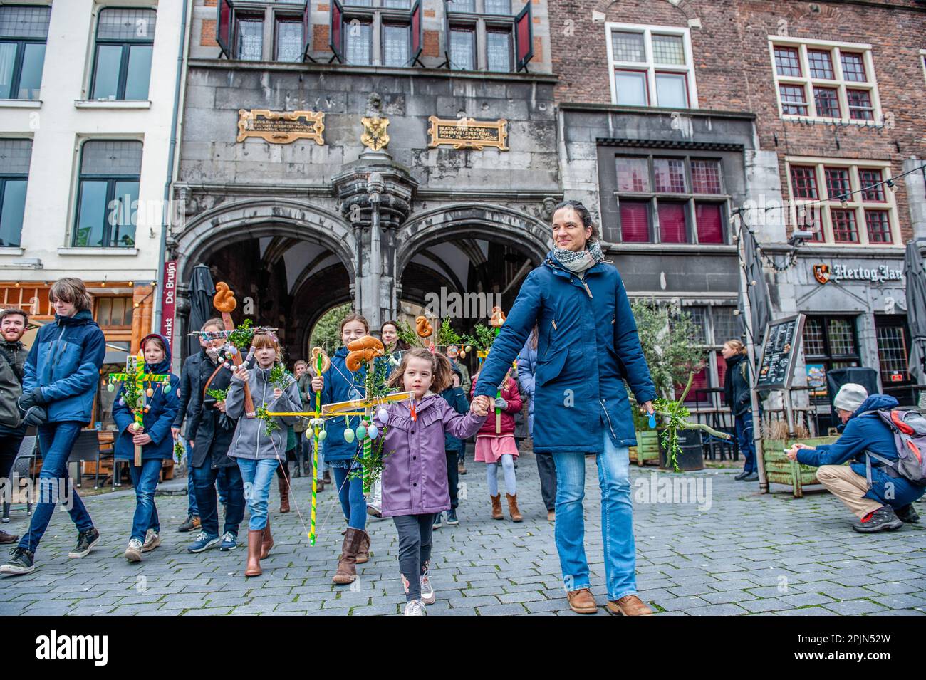Children accompanied by their parents are seen walking with decorated ...