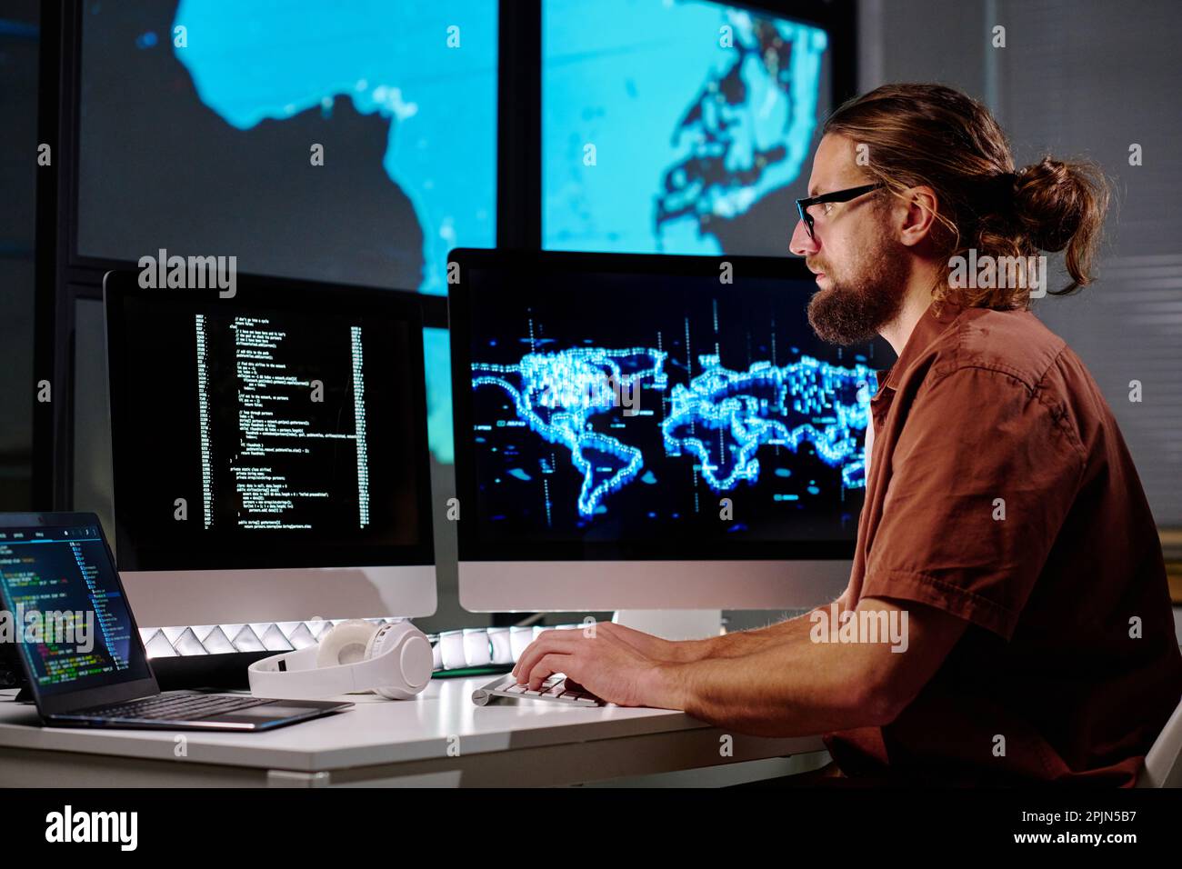 Side View Of Young Serious Male Programmer Decoding Data On Computer Screen And Typing On 3799