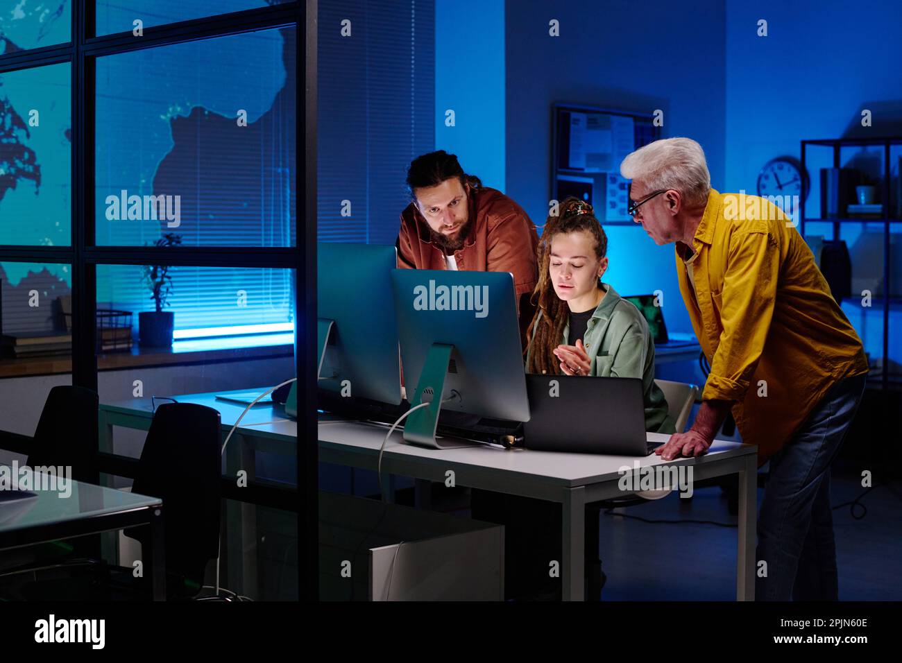 Three colleagues working over new project or software in front of ...