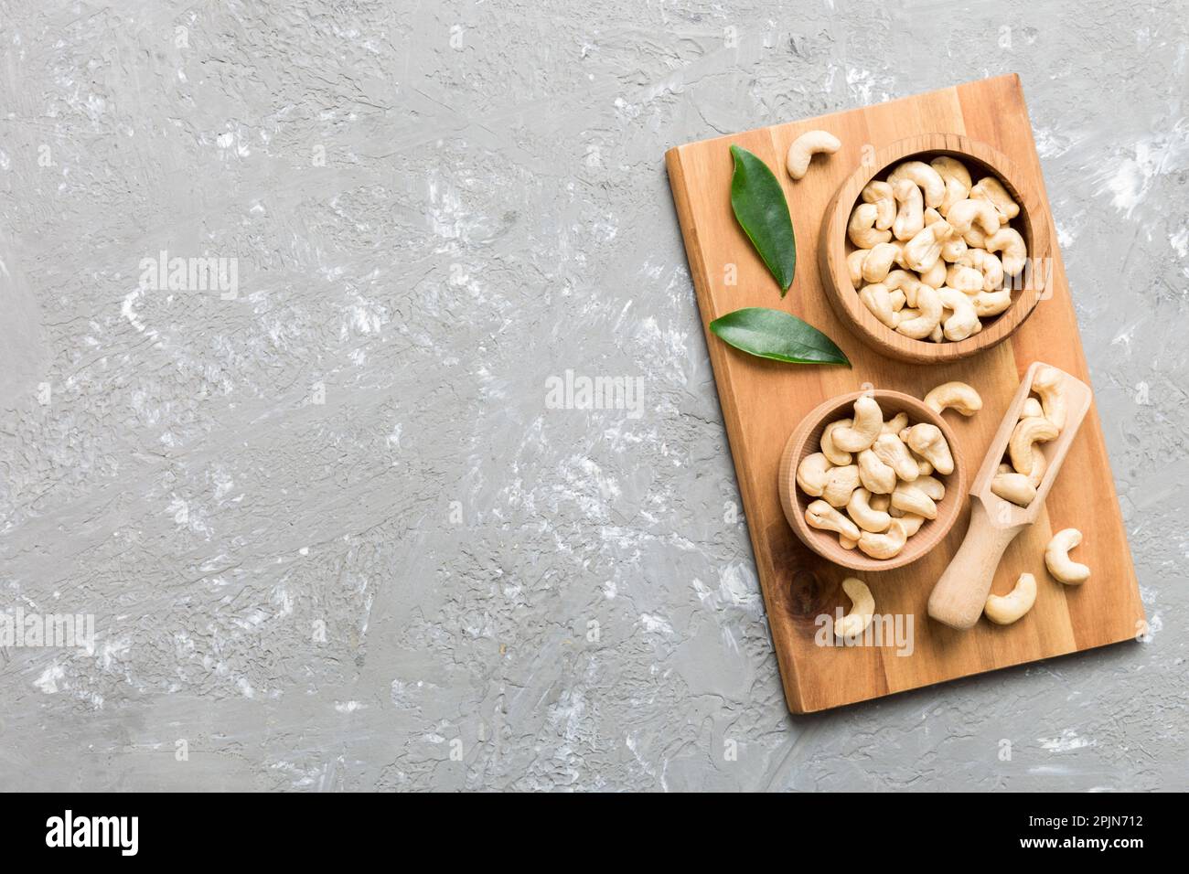 cashew nuts in wooden bowl on table background. top view. Space for ...