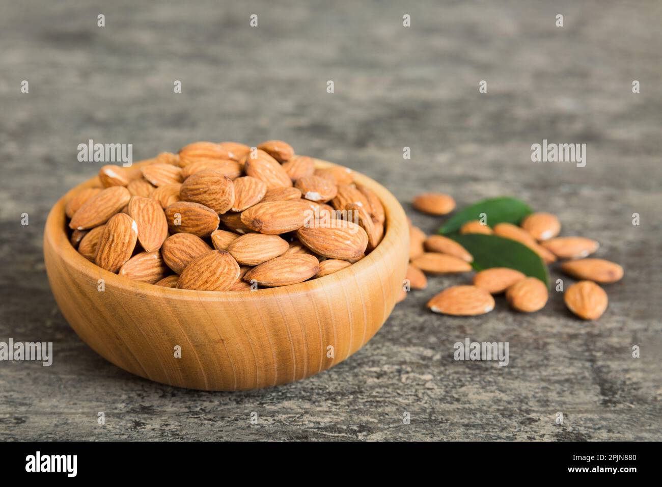 Fresh healthy Almond in bowl on colored table background. Top view ...