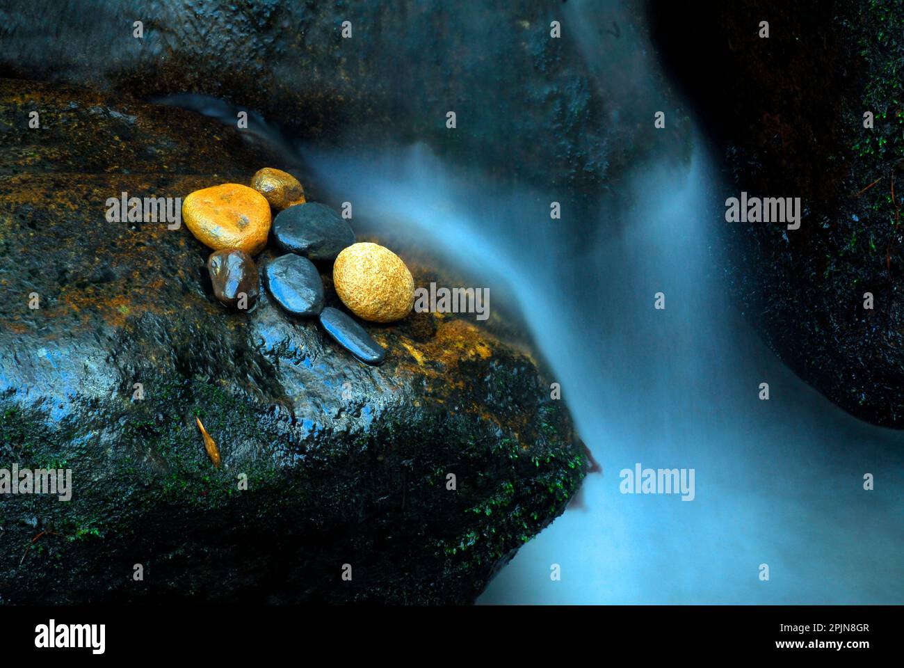 Small waterfall and rounded pebbles in a stream Stock Photo - Alamy