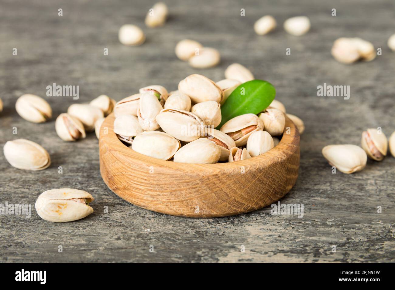 Fresh healthy Pistachios in bowl on colored table background. Top view ...