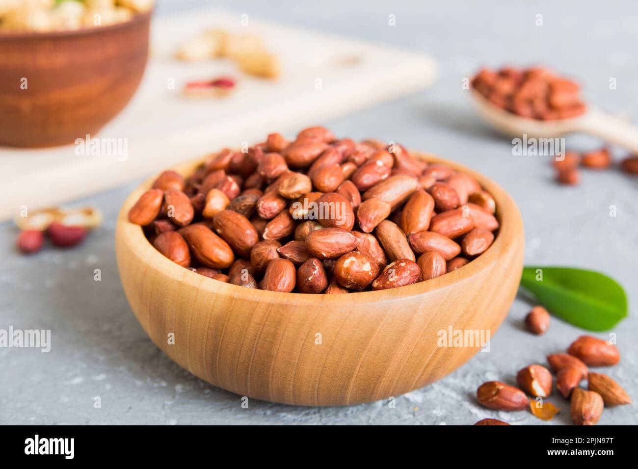 Fresh healthy peanuts in bowl on colored table background. Top view ...