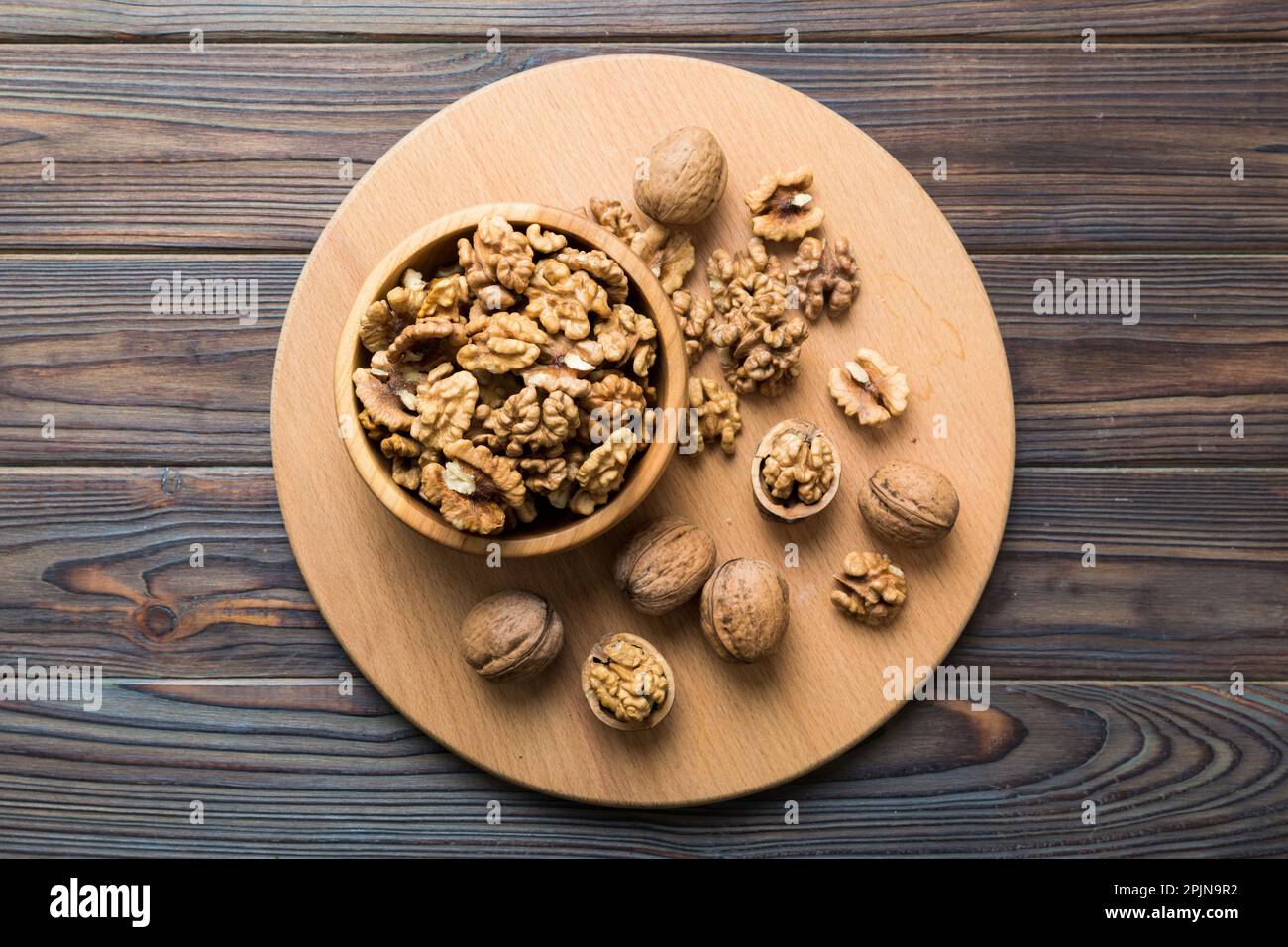 Fresh healthy walnuts in bowl on colored table background. Top view ...