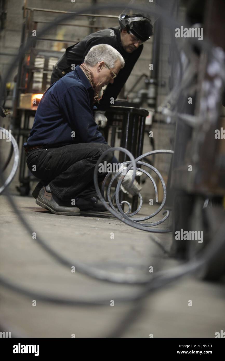 Jefferson Mack (bottom) and Agustine Martinez (top), blacksmith, look ...