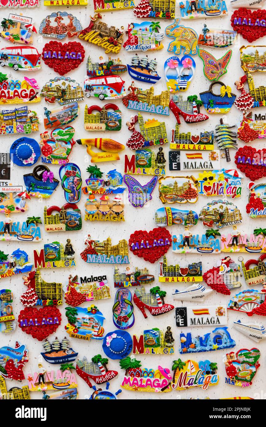 Malaga fridge magnets on white background on display outside a tourist ...